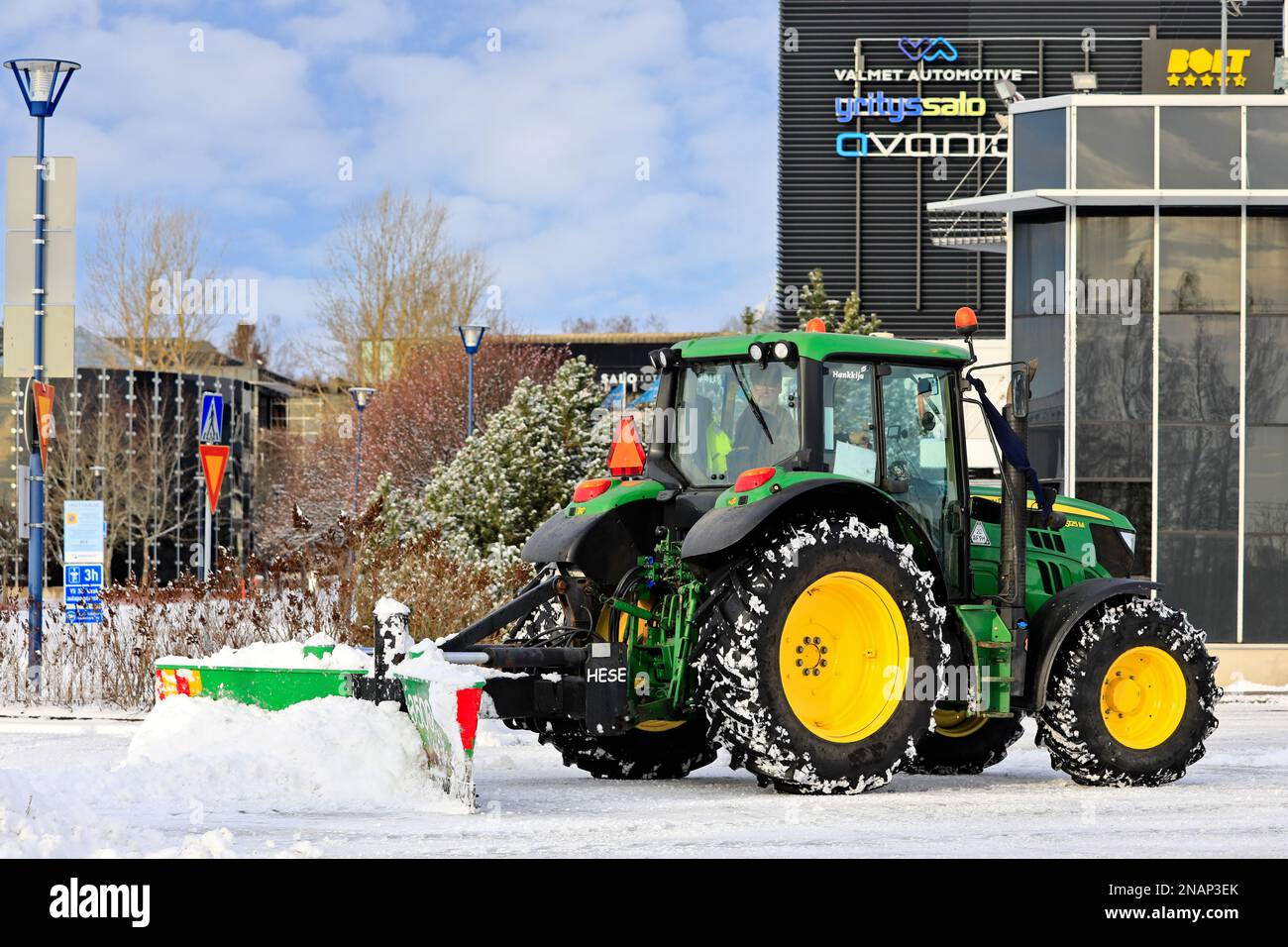 John Deere 5125M tractor removing snow with Hese 3500 two-winged rear ...
