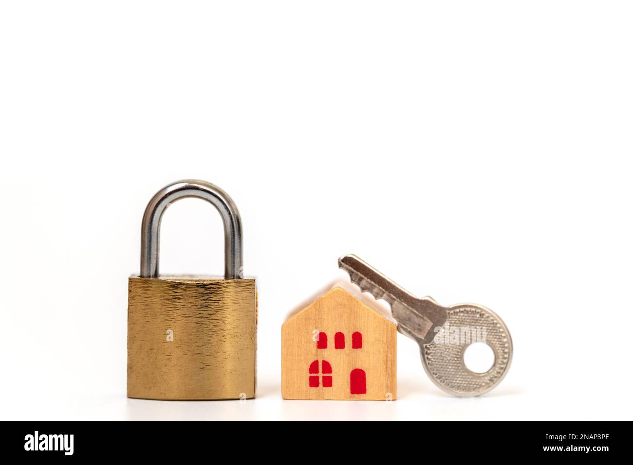 Home Loan and Security Concept. Closeup of wooden house toy with master ...