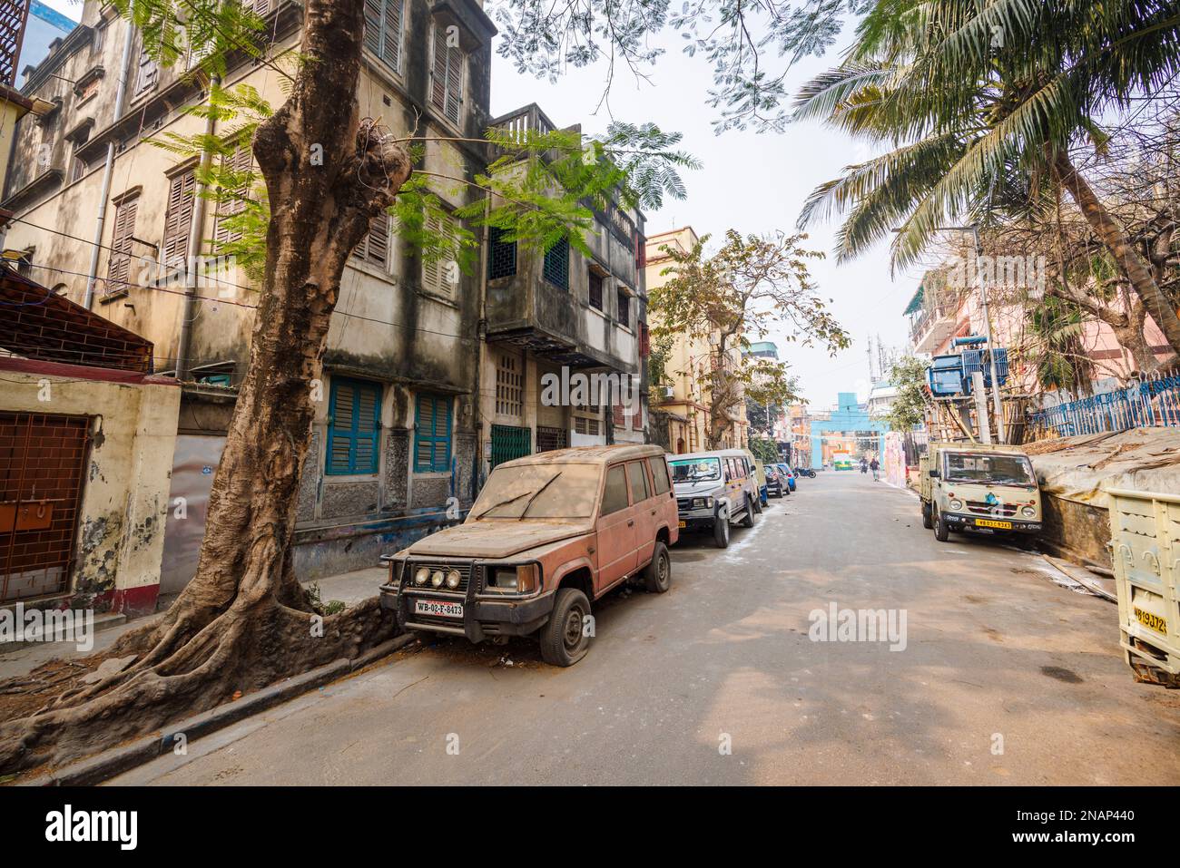 A rusty battered old car or van (a Tata Sumo) parked in the street in ...