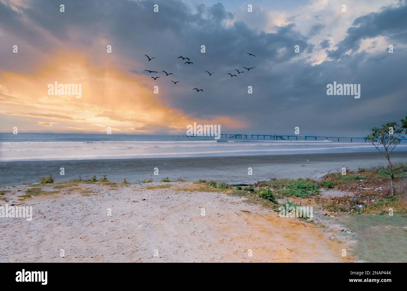 A beautiful bridge on the Inani beach at sunset cloudy and purple sky ...