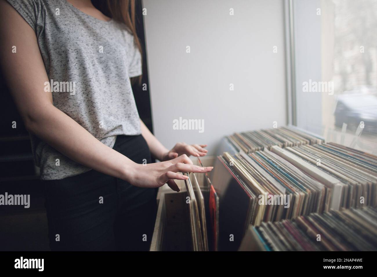 Choosing retro vinyl records. Music background Stock Photo - Alamy