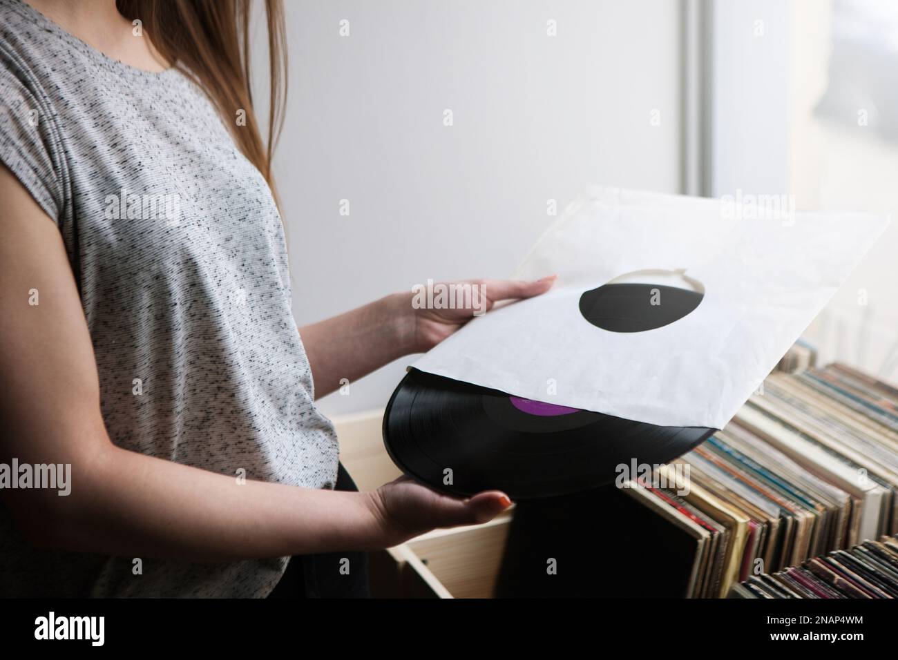 Choosing retro vinyl records in music shop Stock Photo - Alamy