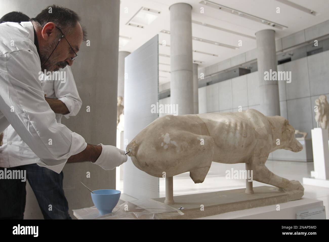 An Acropolis Museum restorer prepares to attach a newly-discovered ...