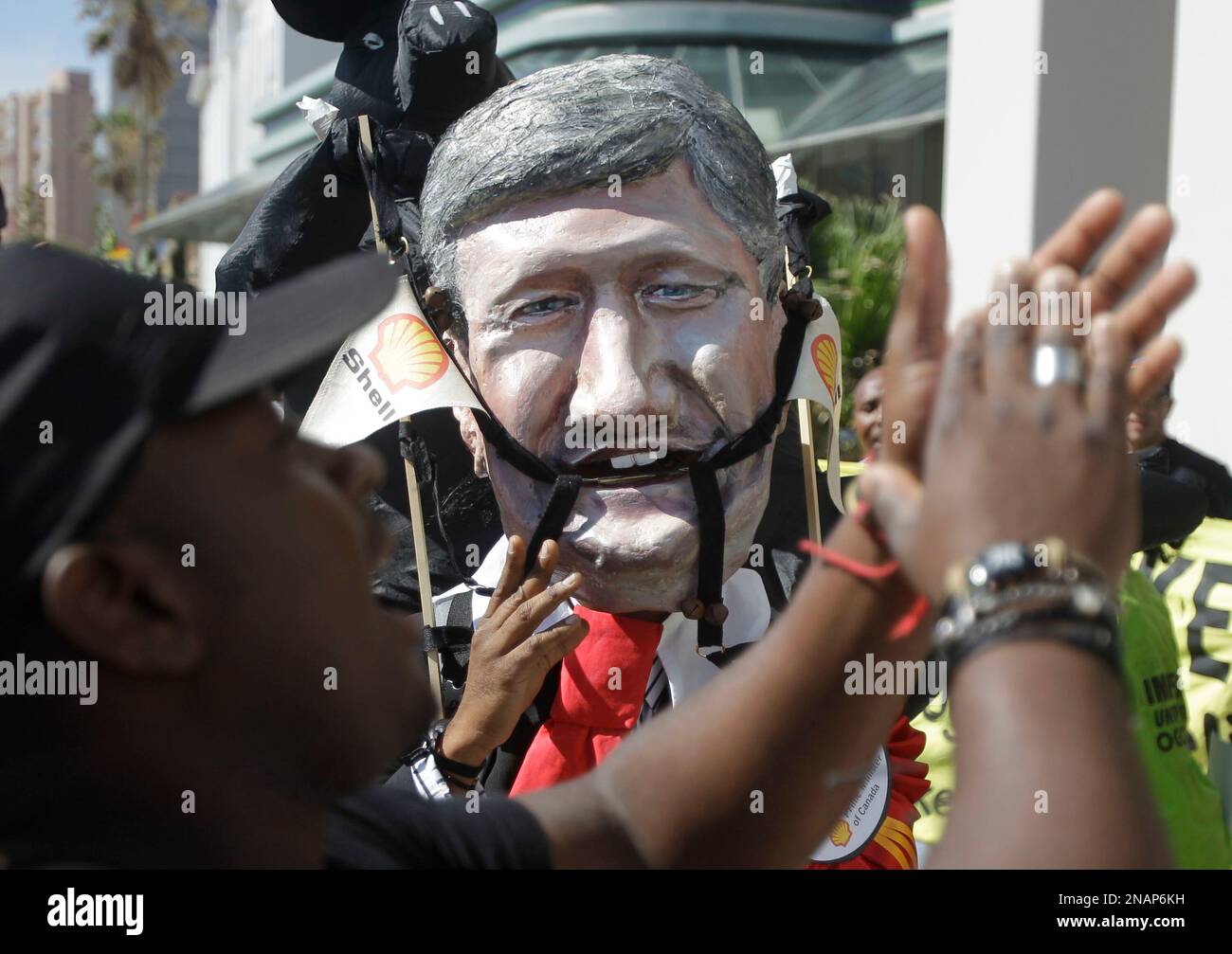 An activist wears a mask depicting the face of the Canadian Prime ...
