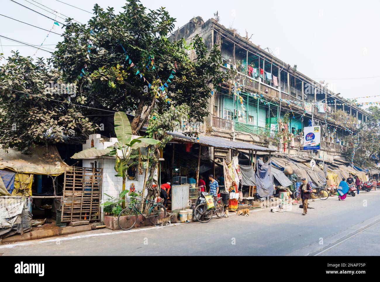 Street scene of roadside shops, stalls and kiosks in the shopping area ...