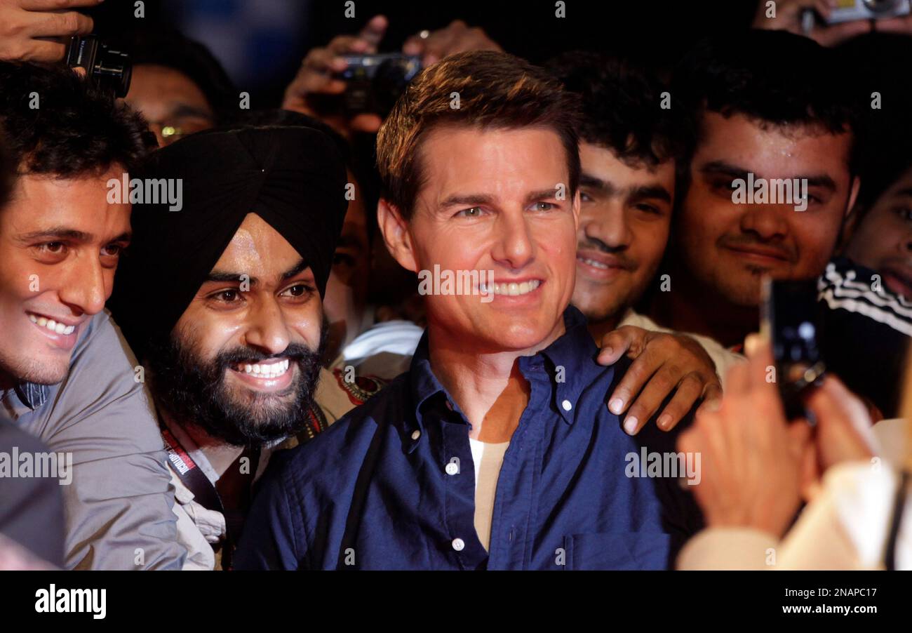 U.S. actor Tom Cruise, center, poses with Indian fans as he arrives for ...