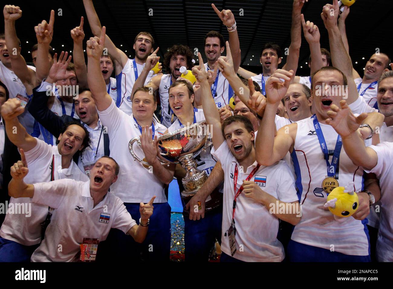 The Russian volleyball team members celebrate with the trophy after ...
