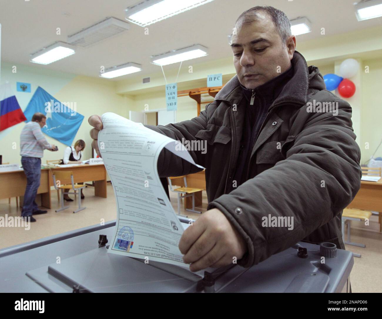 A man casts his ballot at a polling station in Yuzhno-Sakhalinsk, at ...