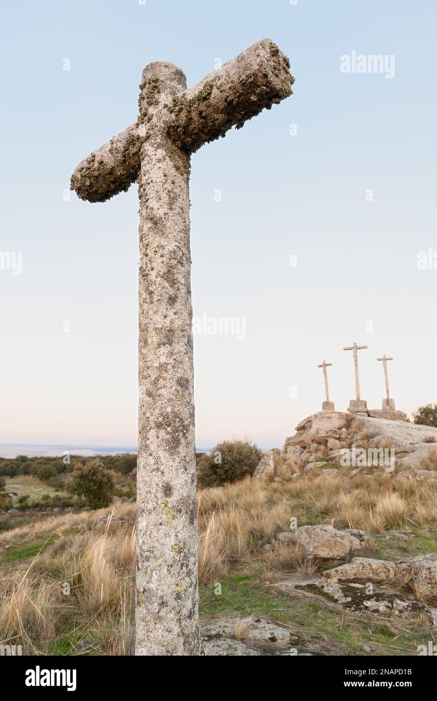 Three Crosses of carved stone on granite rock at dusk of Heaven Stock ...
