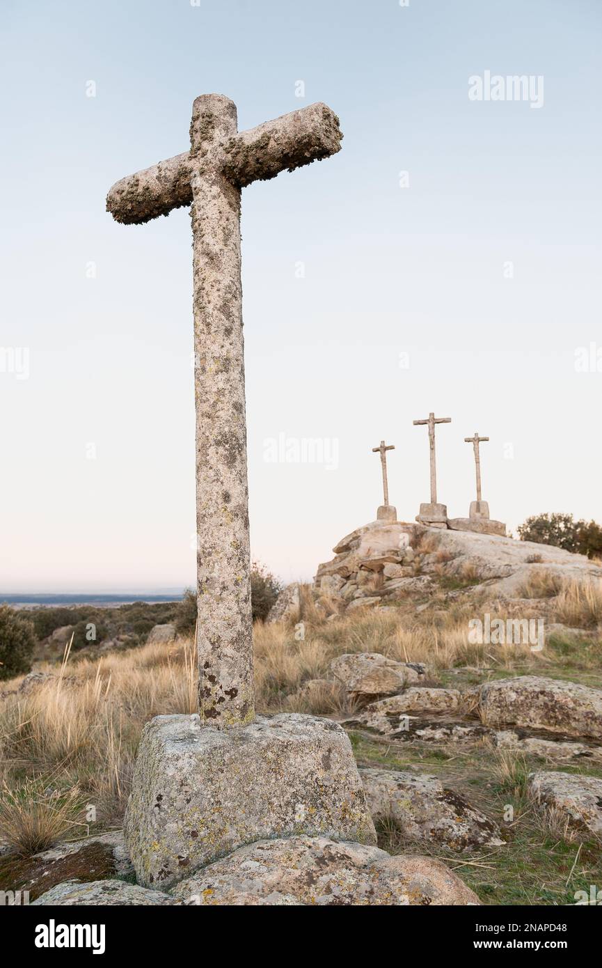 Three Crosses of carved stone on granite rock at dusk of Heaven Stock ...