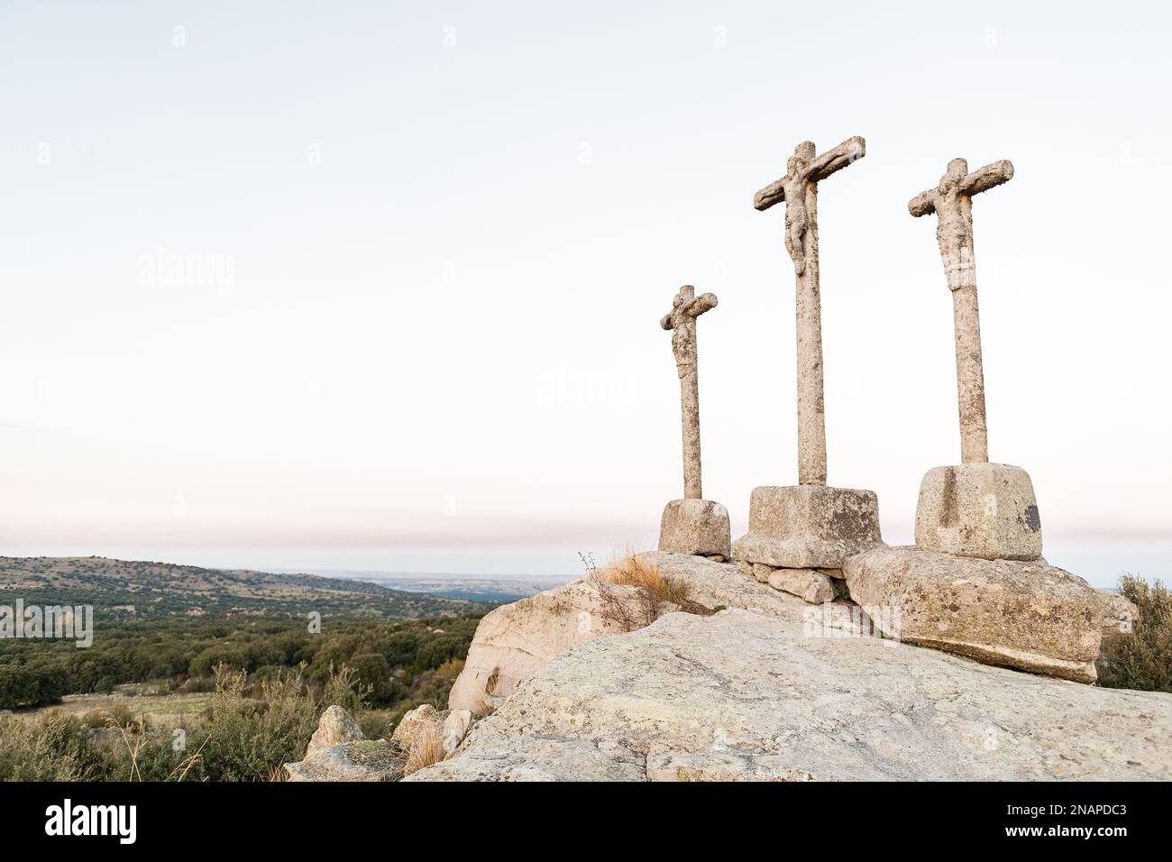 Three Crosses of carved stone on granite rock at dusk of Heaven Stock ...