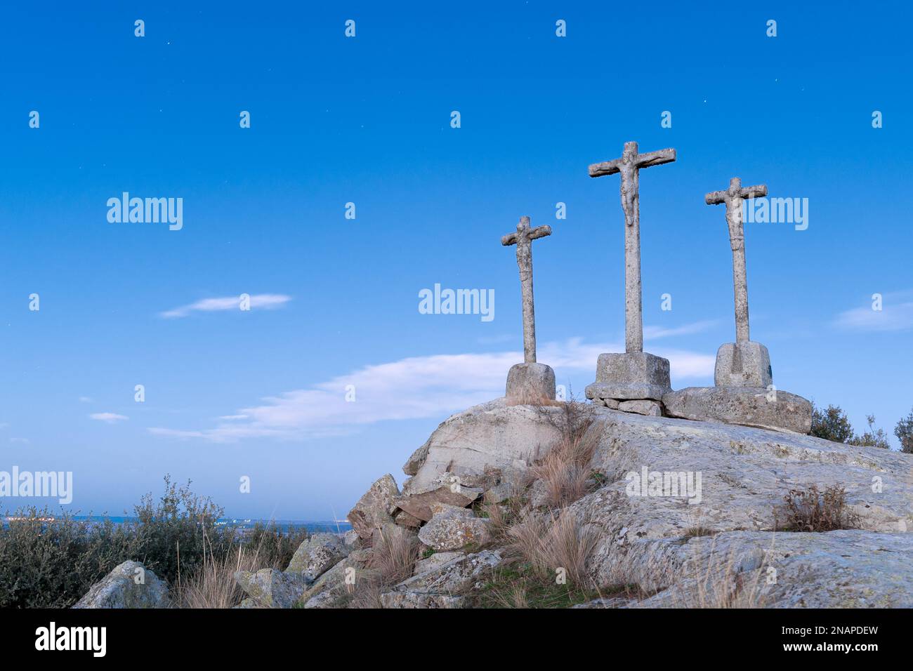 Three Crosses of carved stone on granite rock at dusk of Heaven Stock ...