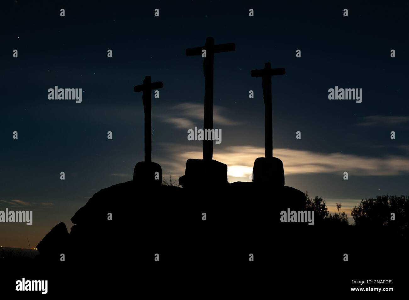 Three Crosses of carved stone on granite rock at dusk of Heaven Stock ...