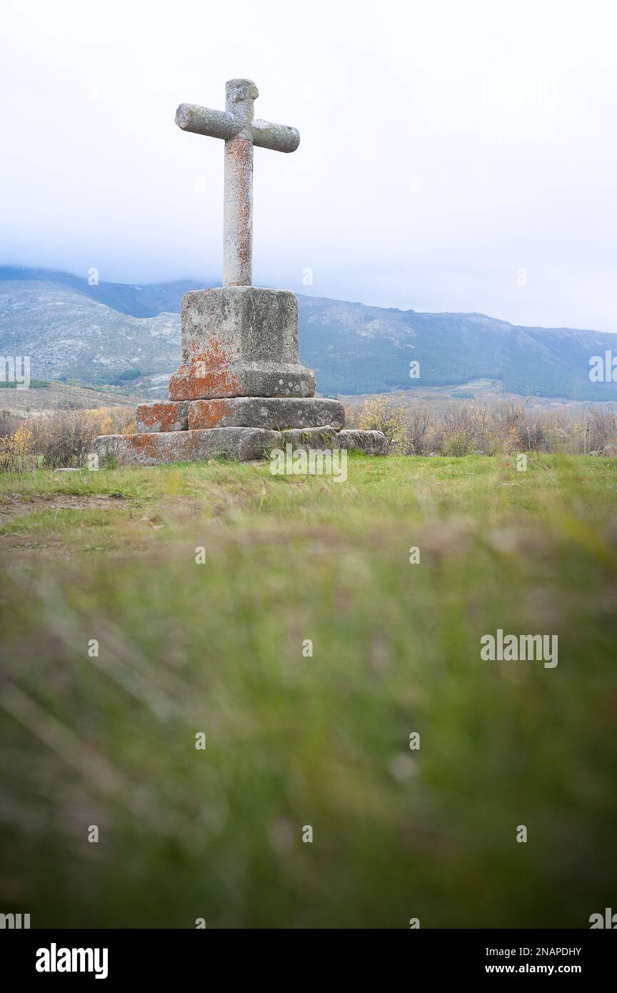 religious symbol of stone on blue sky with black clouds Stock Photo - Alamy