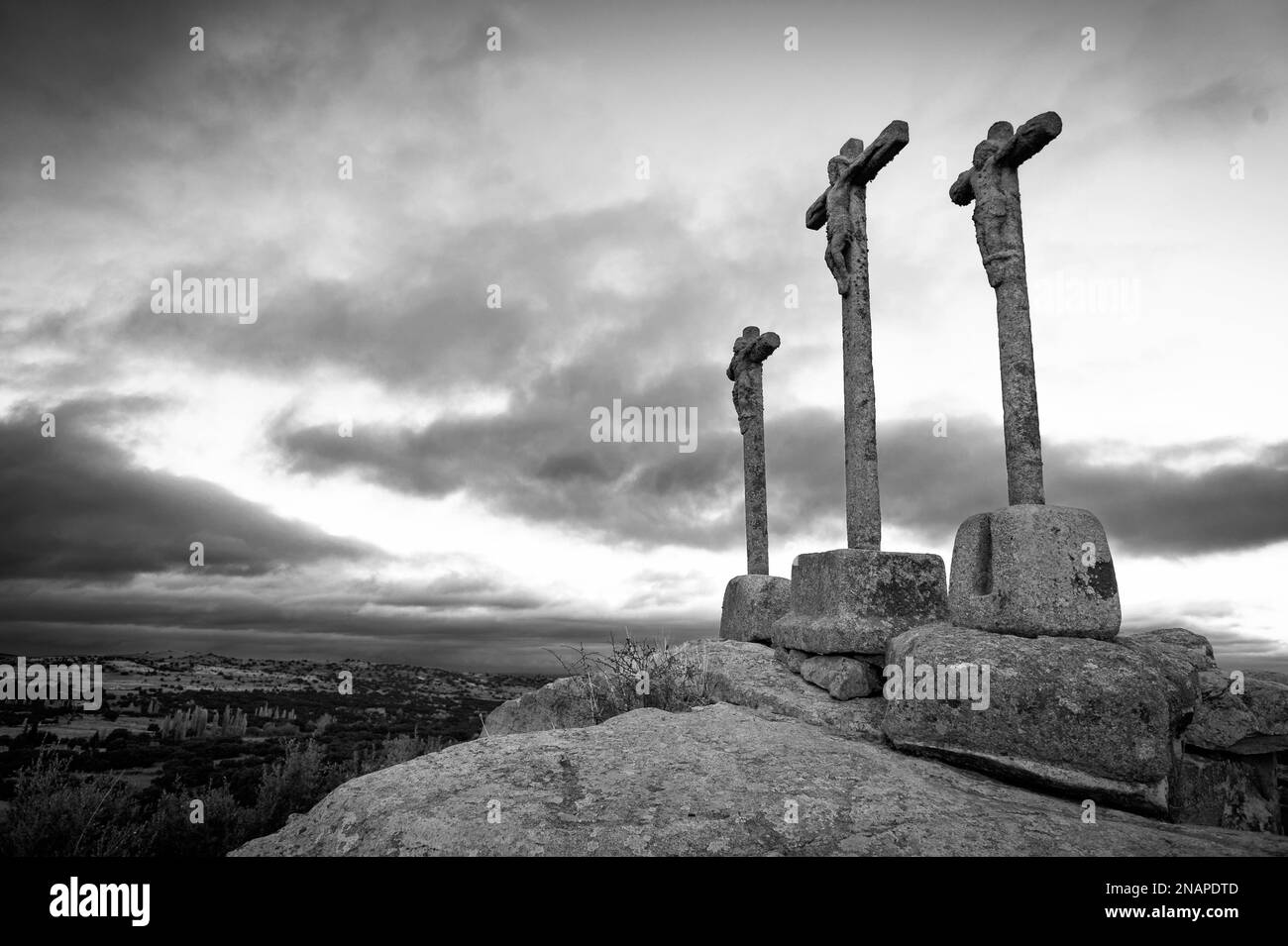 Silhouette of three religious crosses carved in stone with sky at dusk ...