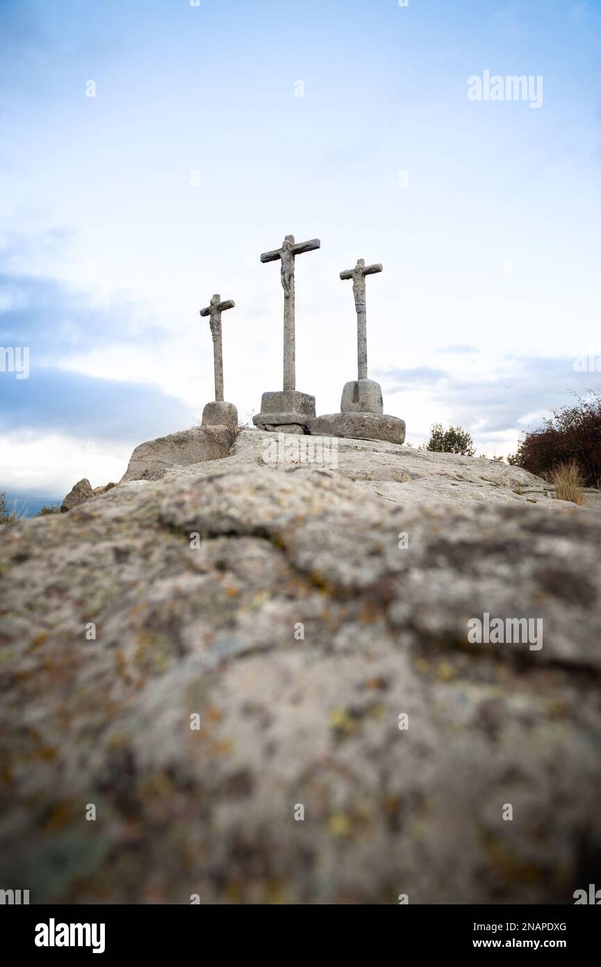 religious symbol of stone on blue sky with black clouds Stock Photo - Alamy