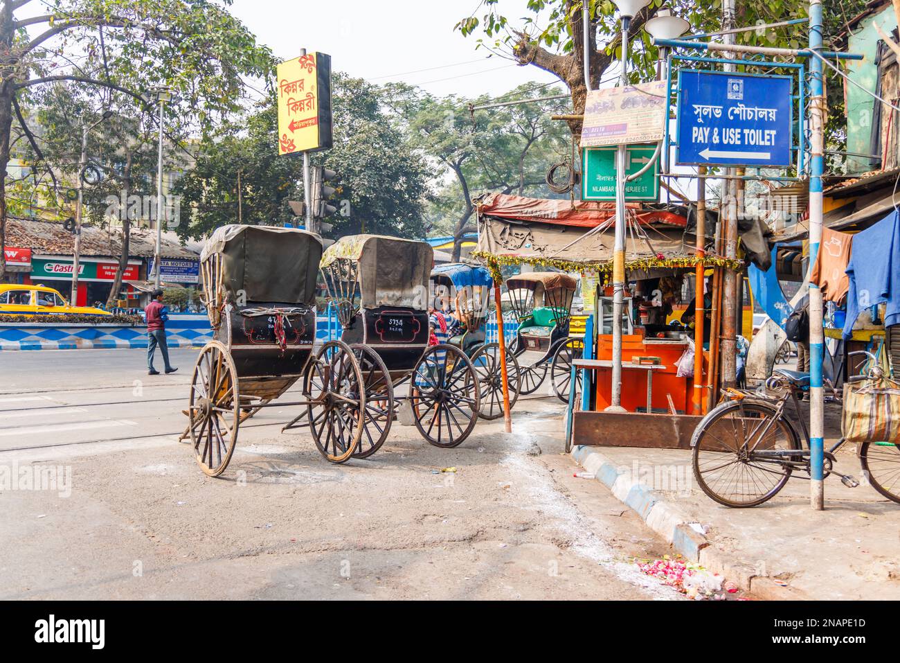 Traditional vintage wooden rickshaws parked in the street in Fariapukur ...