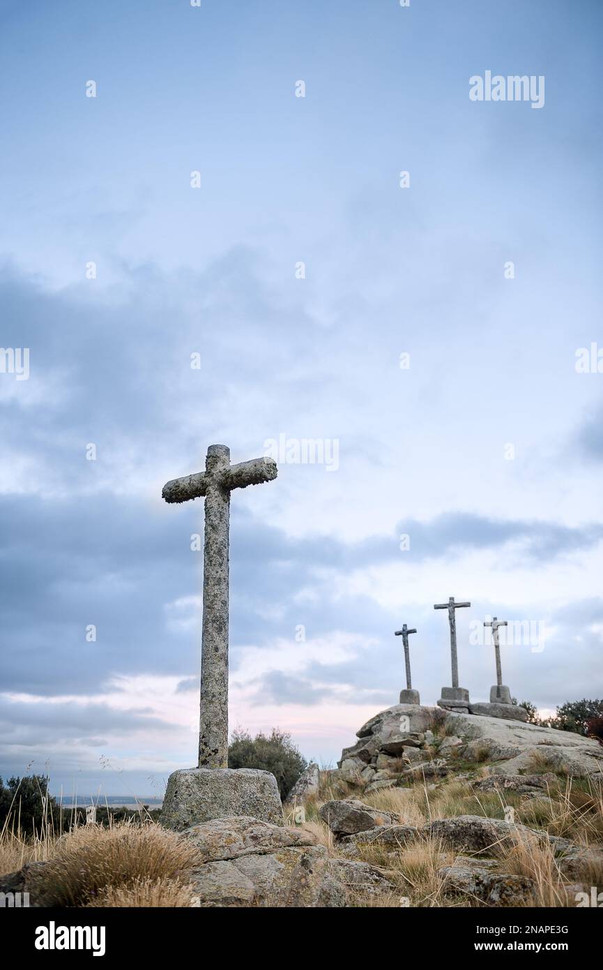 religious symbol of stone on blue sky with black clouds Stock Photo - Alamy