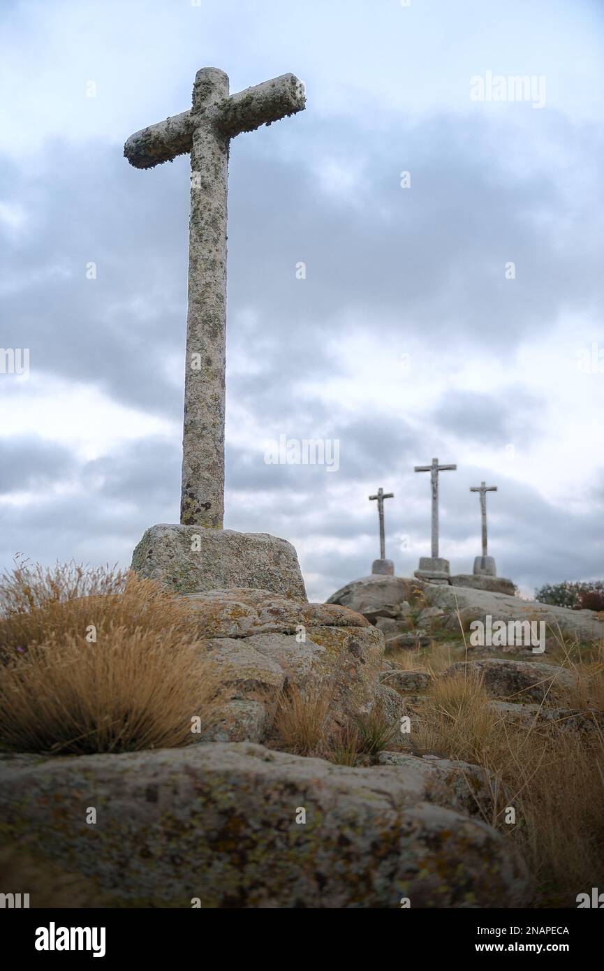 religious symbol of stone on blue sky with black clouds Stock Photo - Alamy