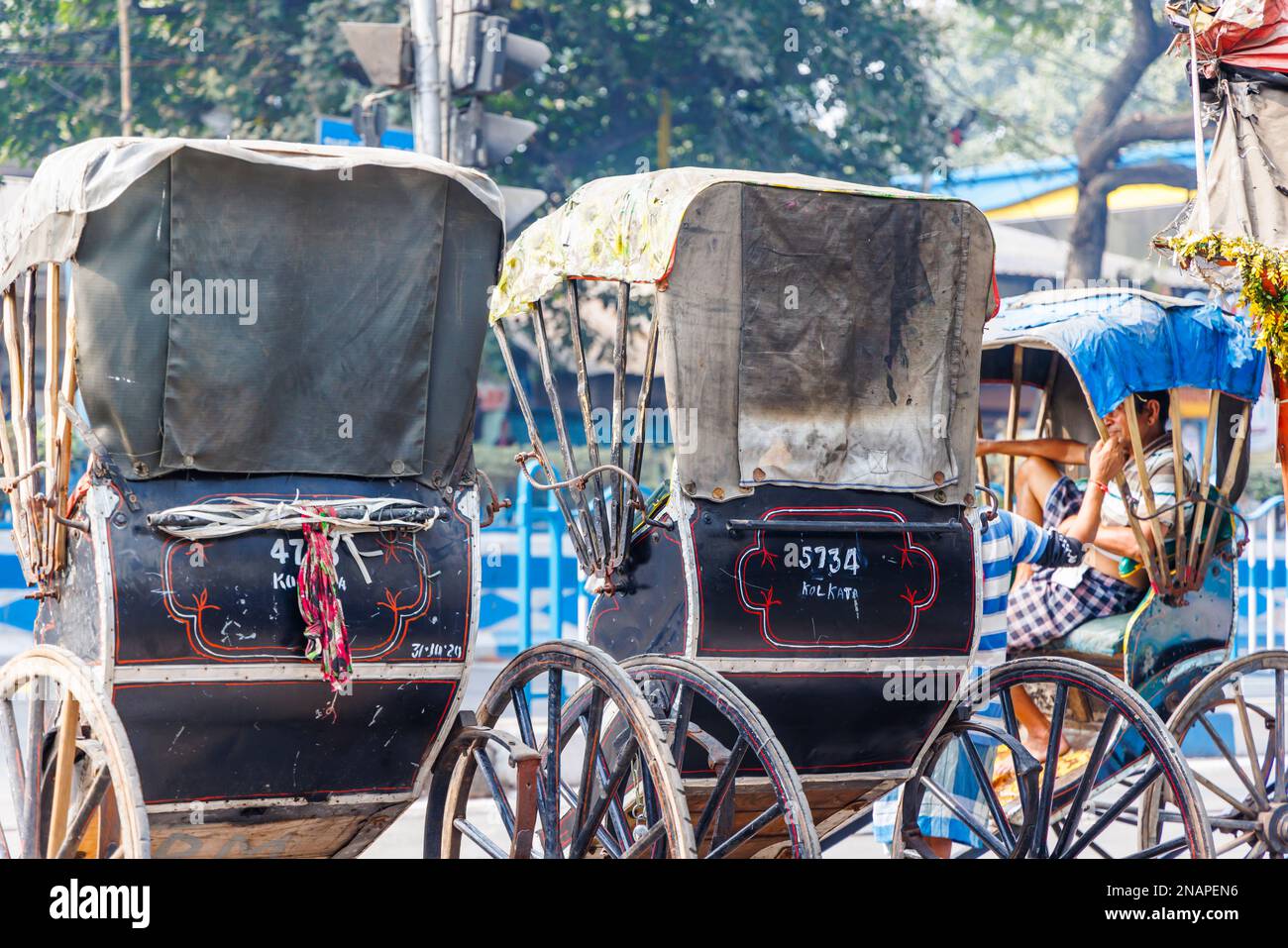 Traditional vintage wooden rickshaws parked in the street in Fariapukur ...