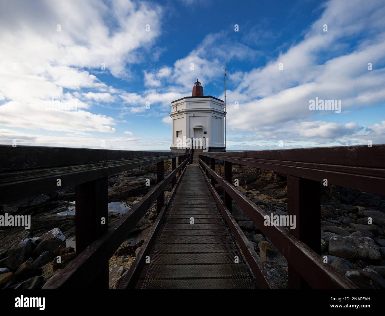 Wooden pathway boardwalk leading to old historical white Stirling Point ...