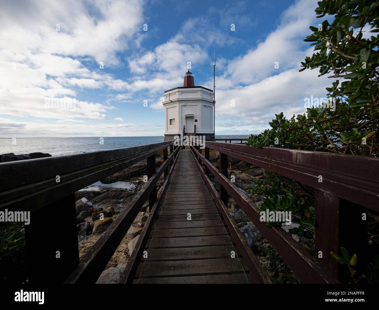 Wooden pathway boardwalk leading to old historical white Stirling Point ...