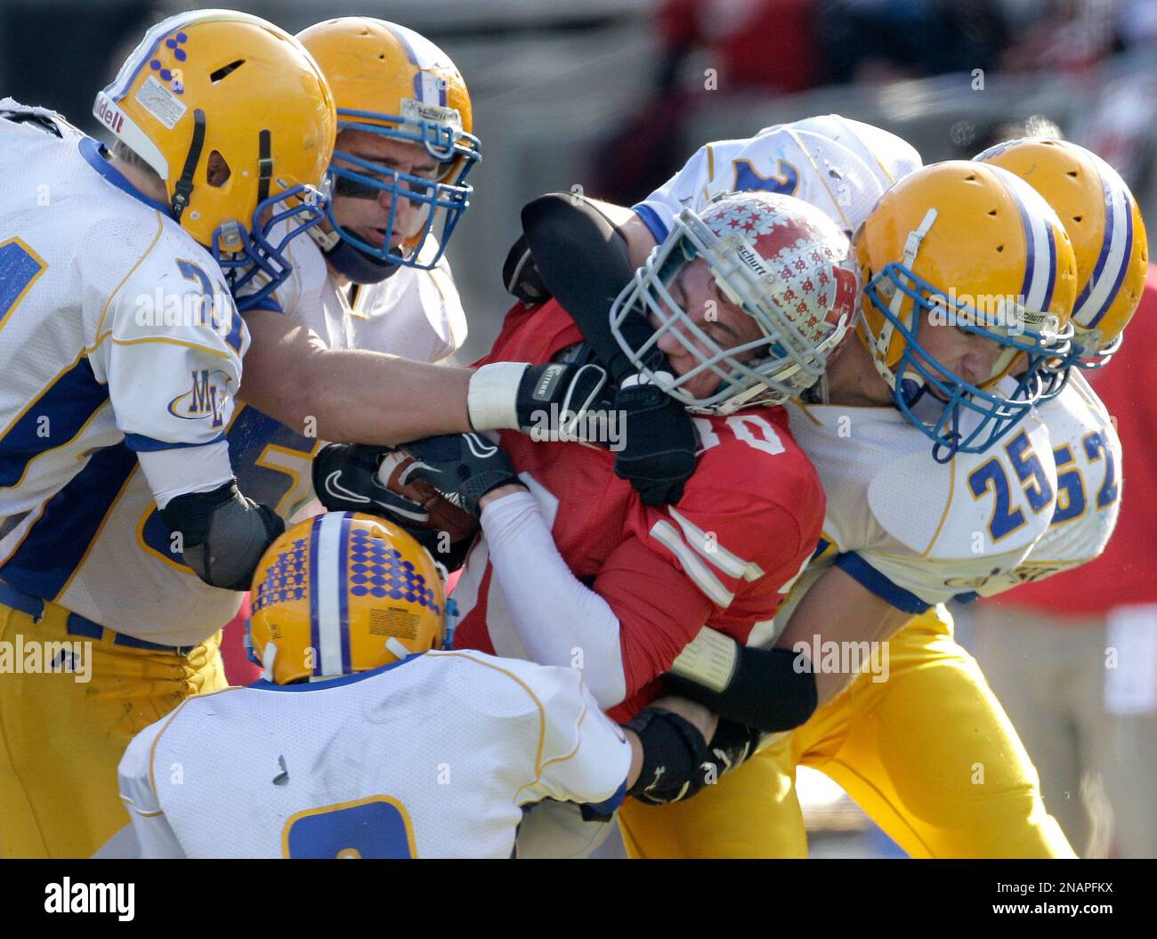 Buckeye Central wide receiver Adam Paynter (30) is wrapped up by of a ...