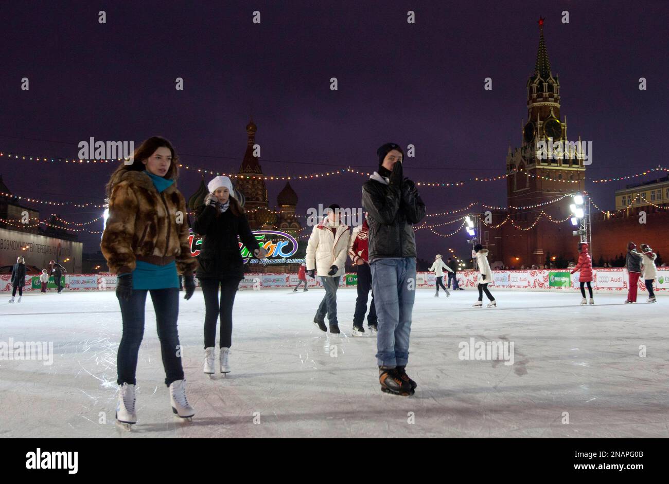 People skate on the ice rink opened on Red Square, with St. Basil ...