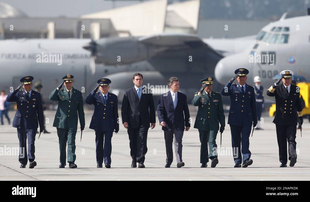 Colombia's President Juan Manuel Santos, fourth from right, walks with ...