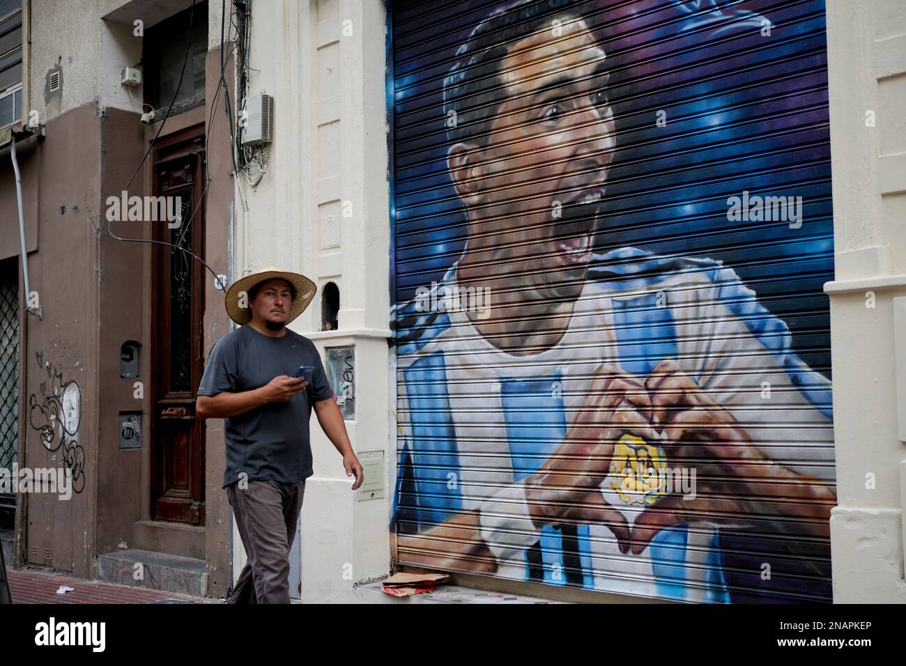 A pedestrian walks past a mural of soccer player Angel Di Maria, by ...
