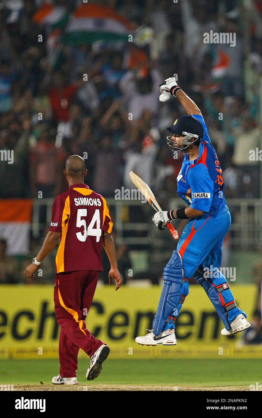 India's batsman Virat Kohli, right, jumps to celebrate scoring a ...