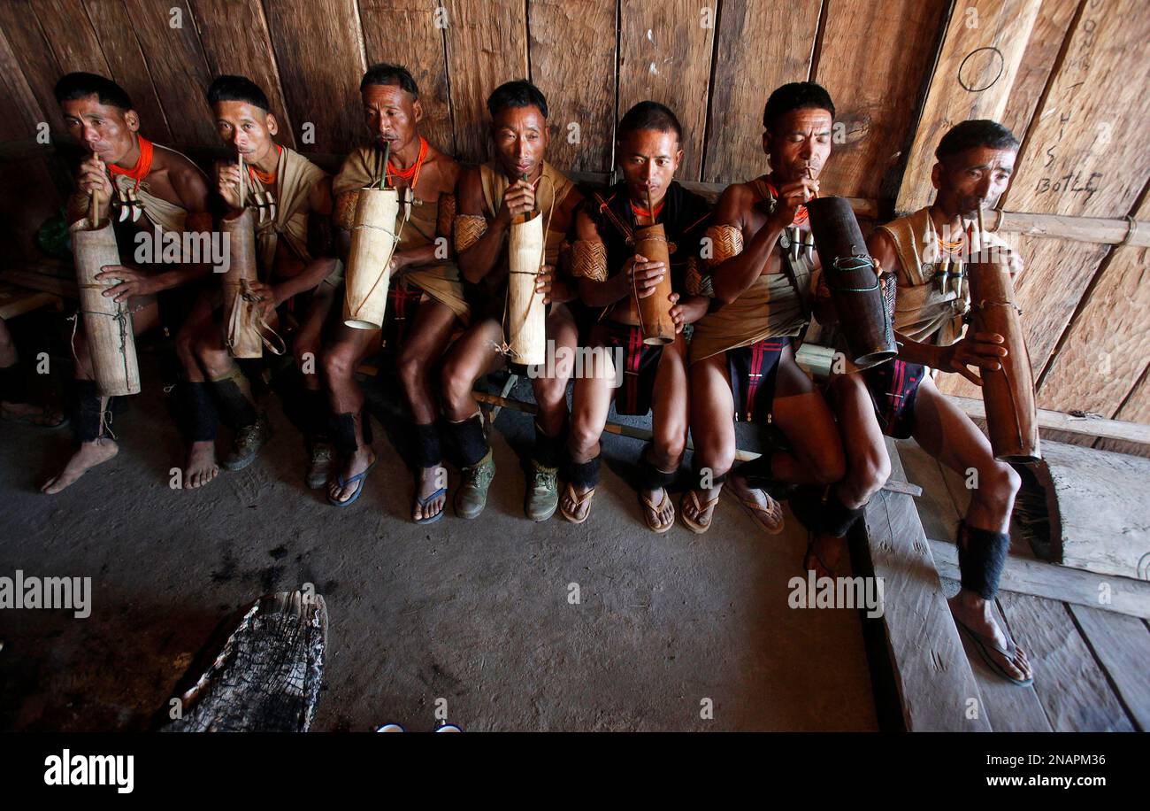 Khiamniungan Naga tribe people with traditional attire drink rice beer ...