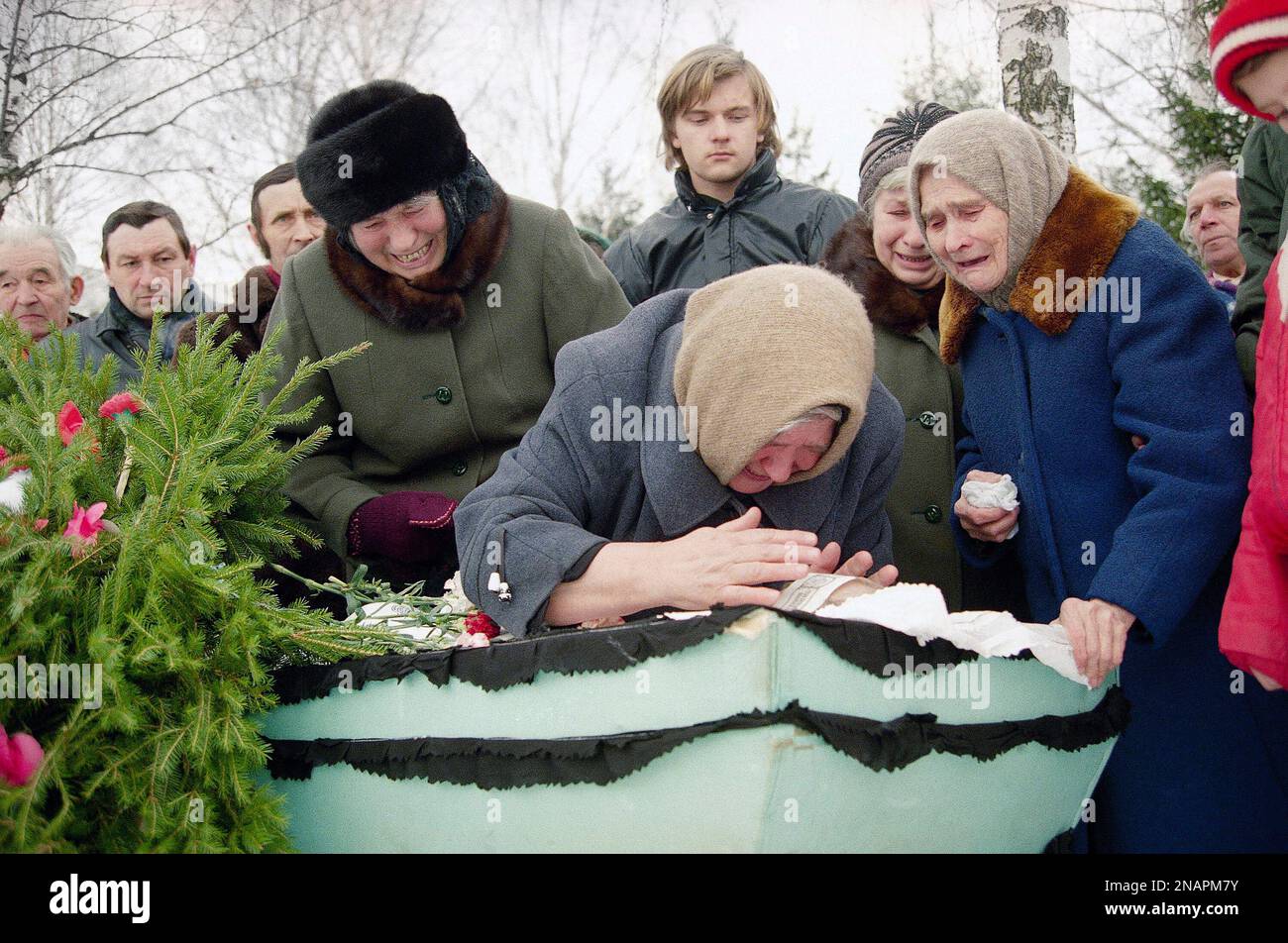 Russian babushkas weep over the dead during funerals at a Moscow ...