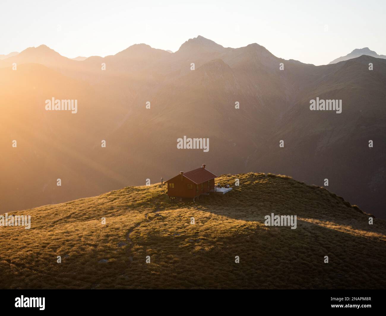 Sunset panorama of red idyllic remote lonely alpine mountain Brewster ...