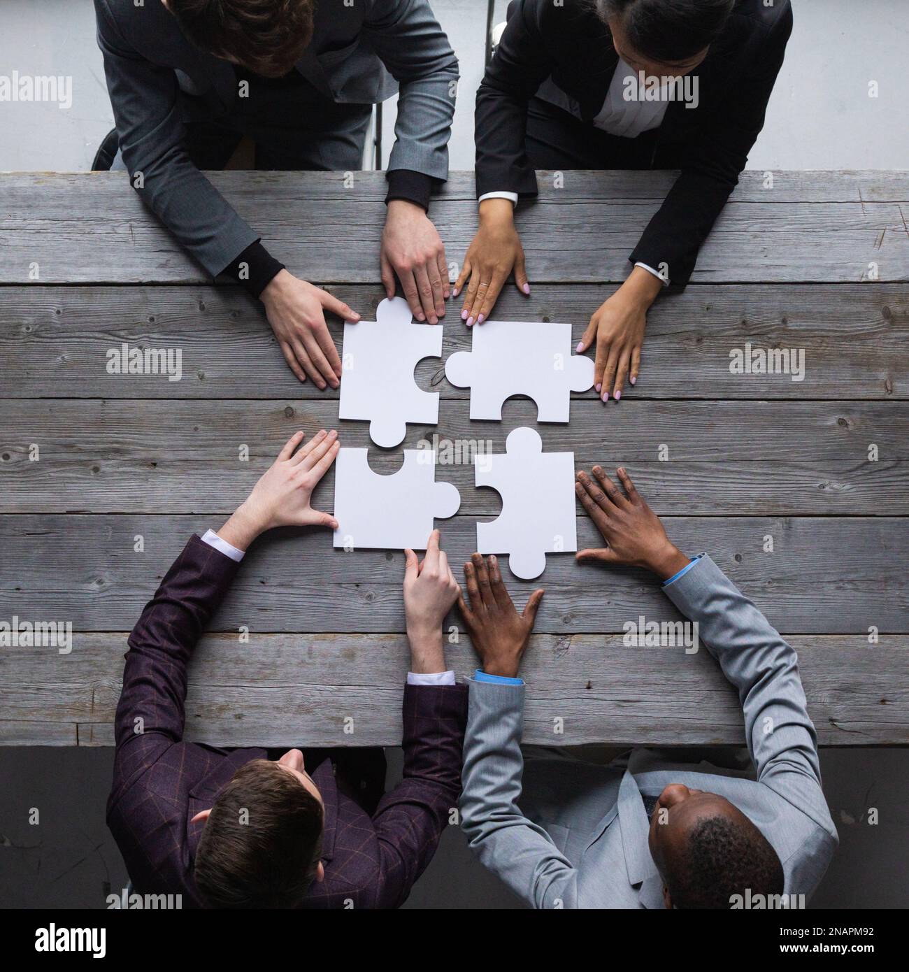 Business teamwork with puzzle finishing project cooperation unity ...