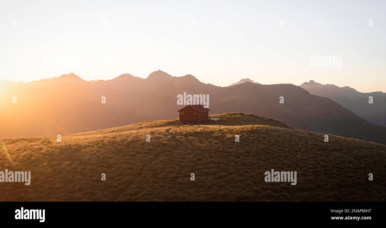 Sunset panorama of red idyllic remote lonely alpine mountain Brewster ...