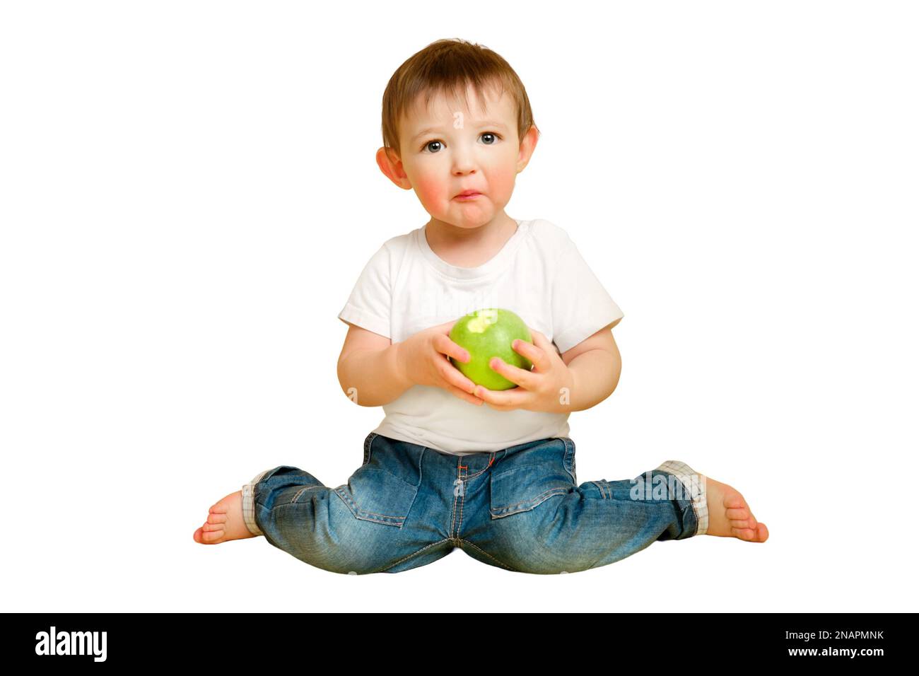 Toddler baby eats a sour apple on a studio isolated on a white ...