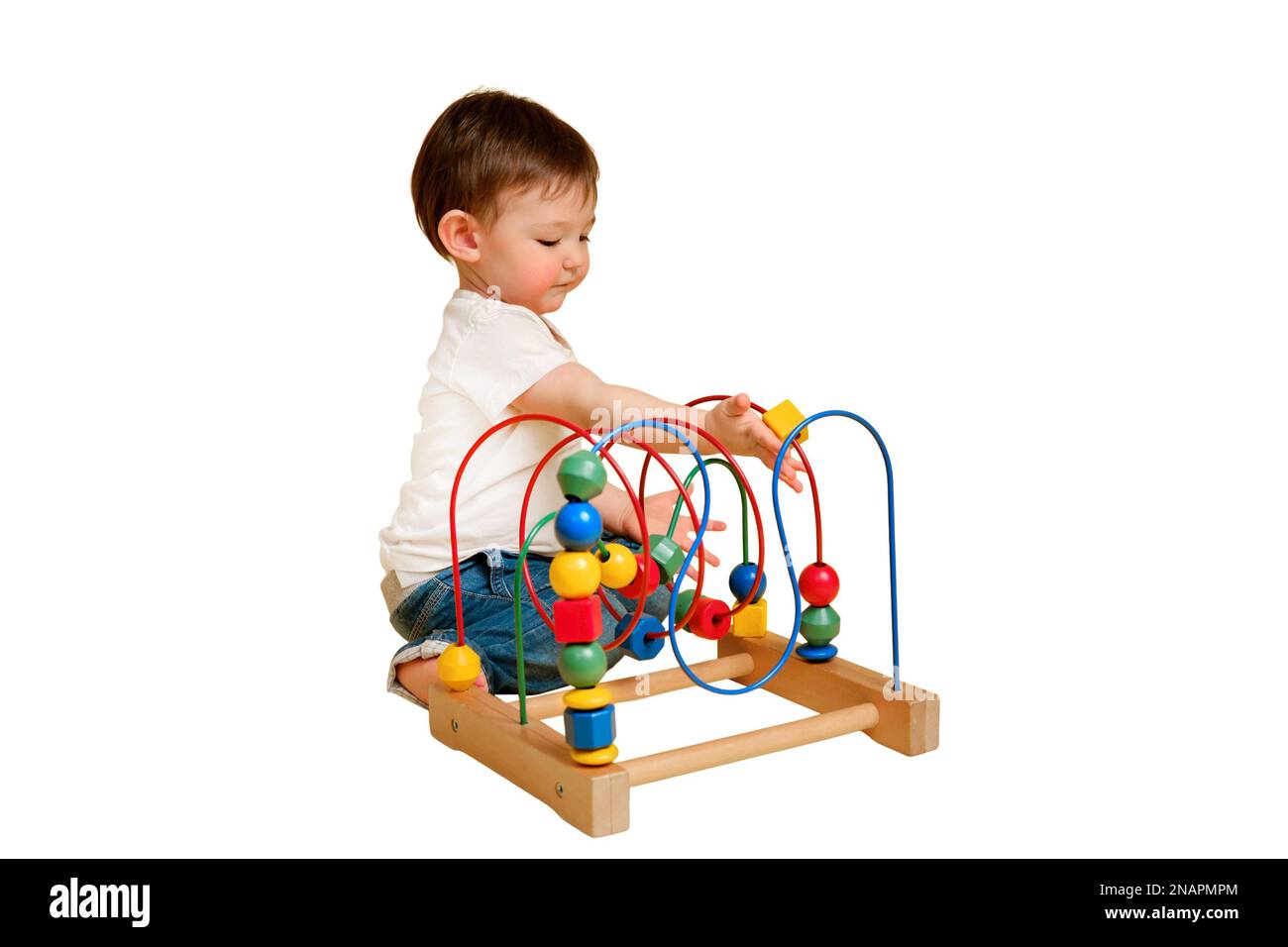 Toddler baby is playing logic educational games on a studio isolated on ...