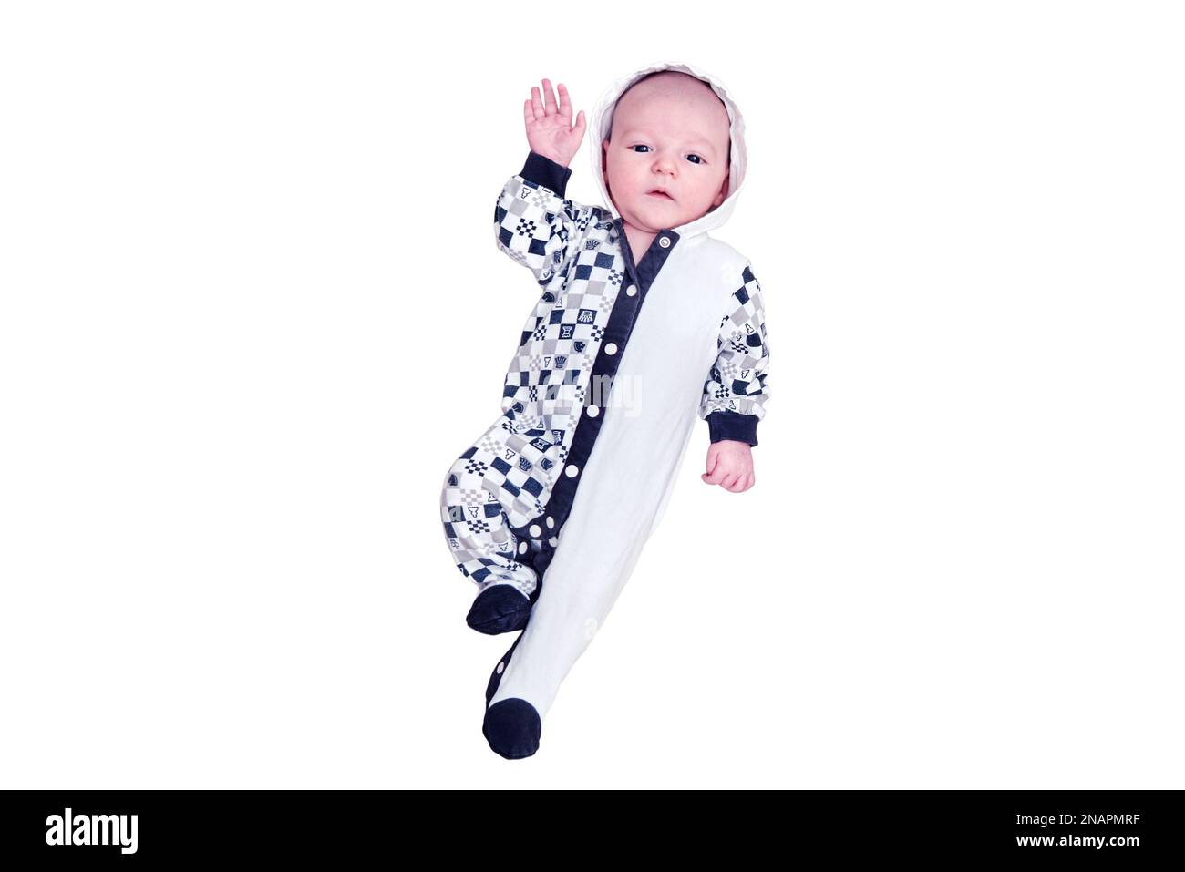 Newborn baby boy in a chess suit near a chessboard with placed pieces ...