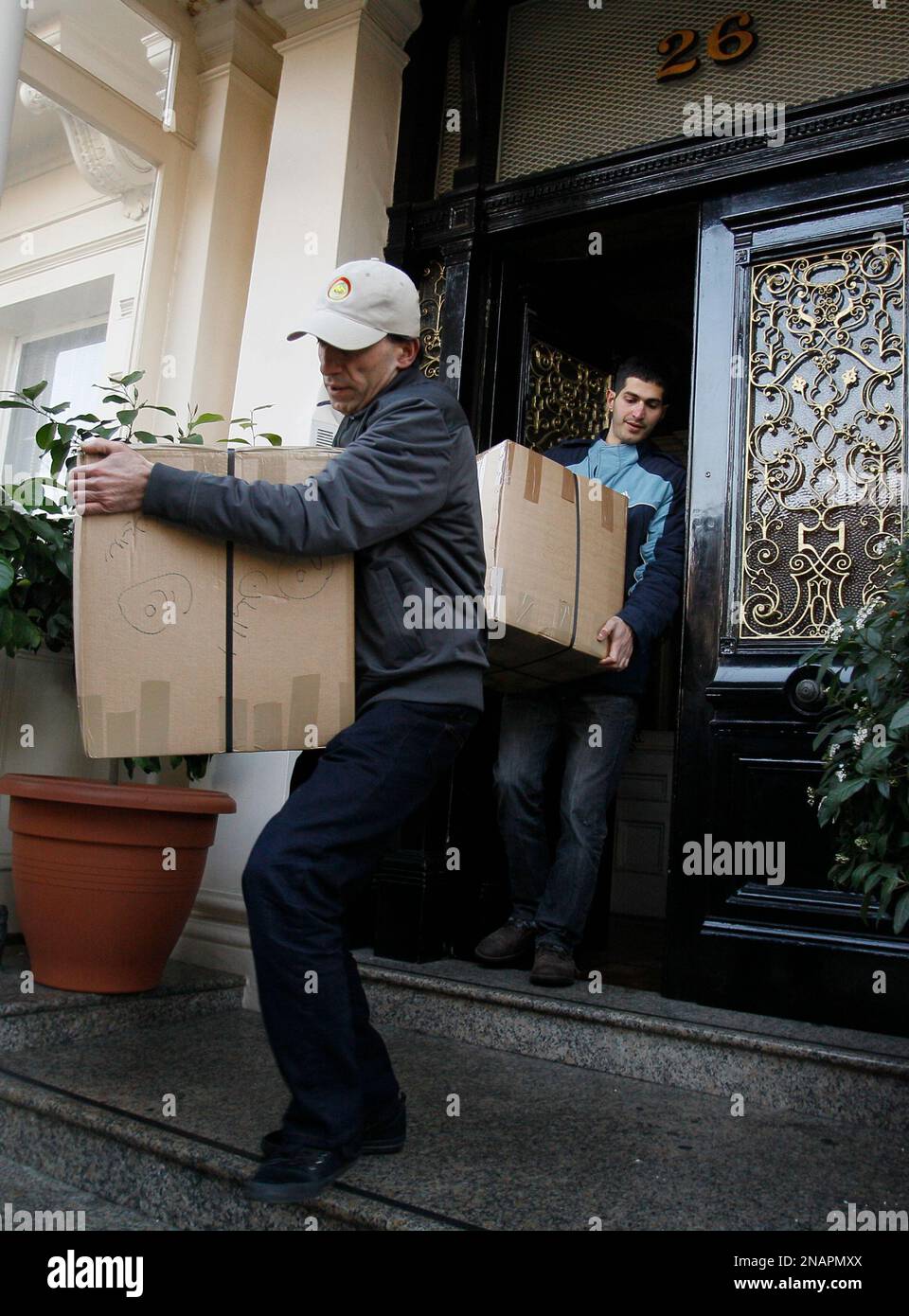 Removal men carry packages from what is believed to be the residence of ...