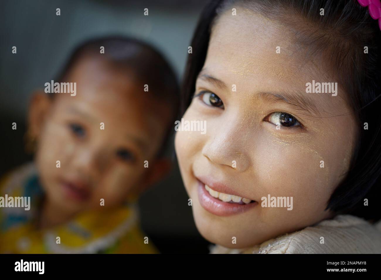 A Myanmar girl wears traditional make up Sandarwood "Thanakha" on her ...