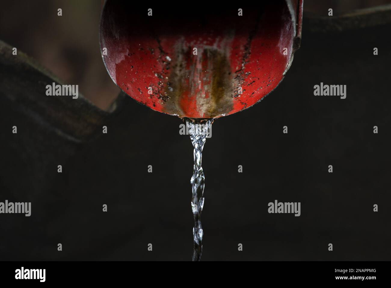 Picture of a flow of water pouring out of a pipe Stock Photo - Alamy