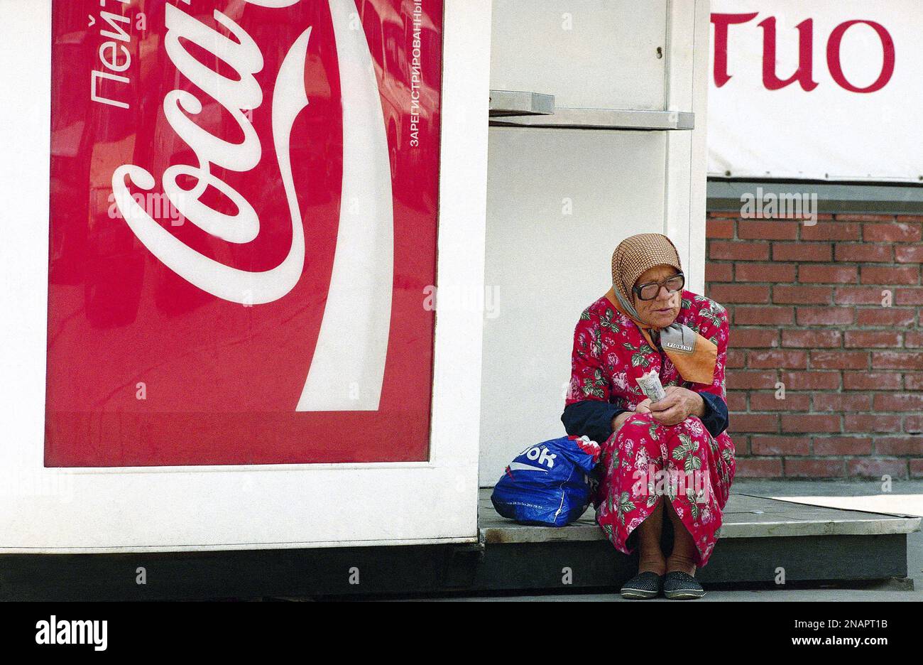 An elderly Russian woman, surrounded by Western symbols of capitalism ...