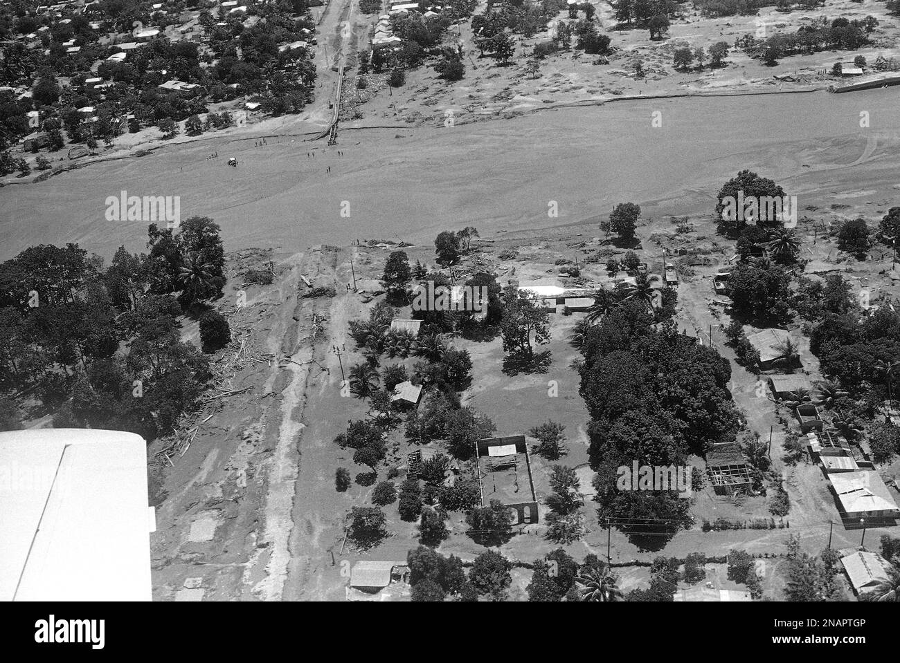Floods wash away bridge over Choloma River near area in Tegucigalpa, Honduras, Sept. 23, 1974 ...