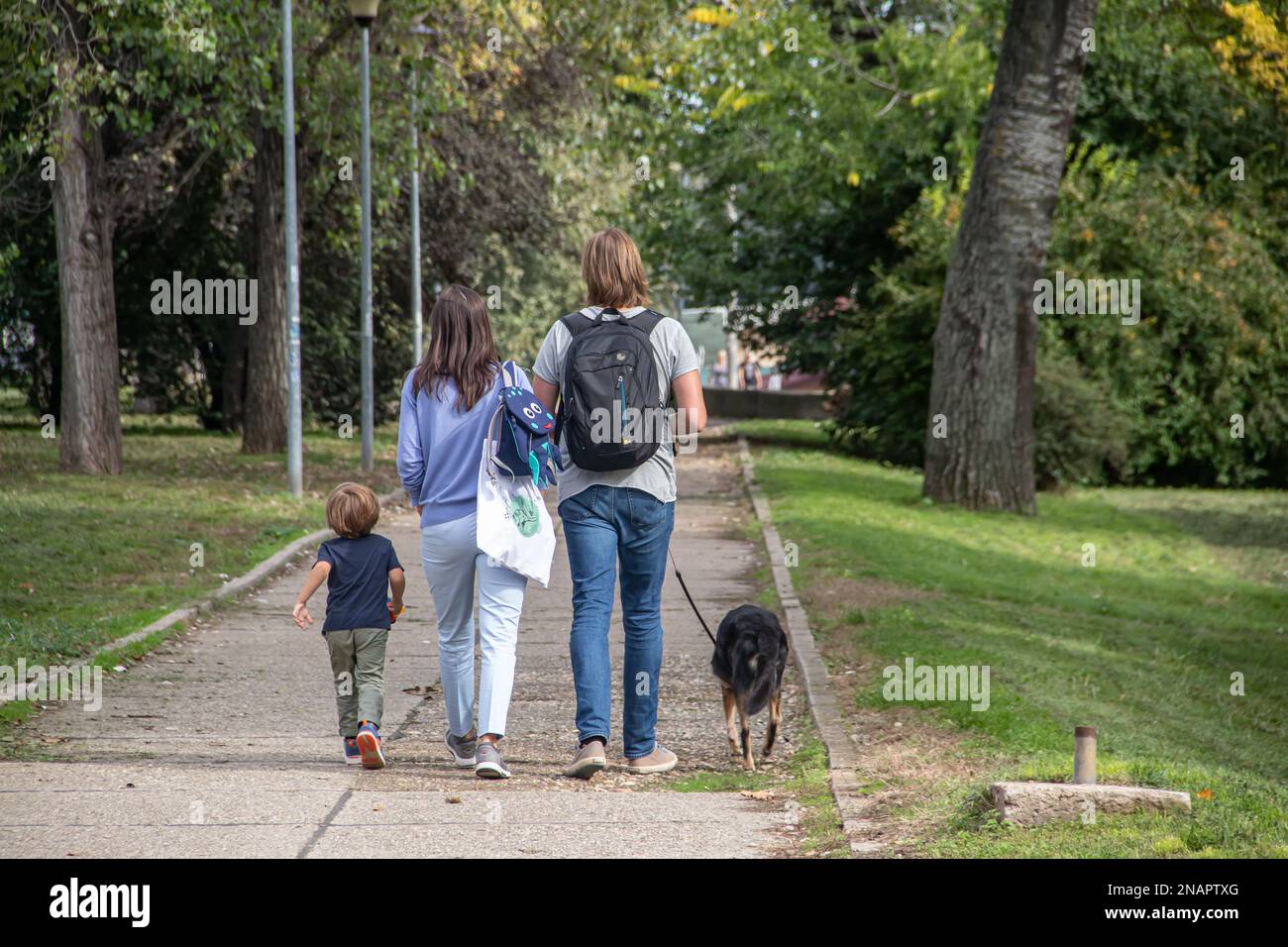 Family with kid enjoying park walk on sunny weekend day Stock Photo - Alamy