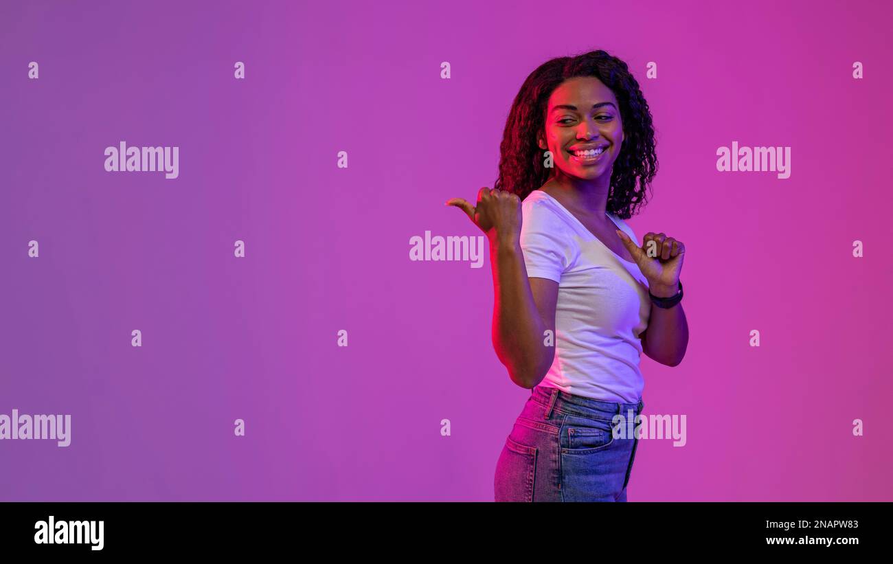 Great Offer. Smiling Black Woman Pointing Back With Two Thumbs Up Stock ...