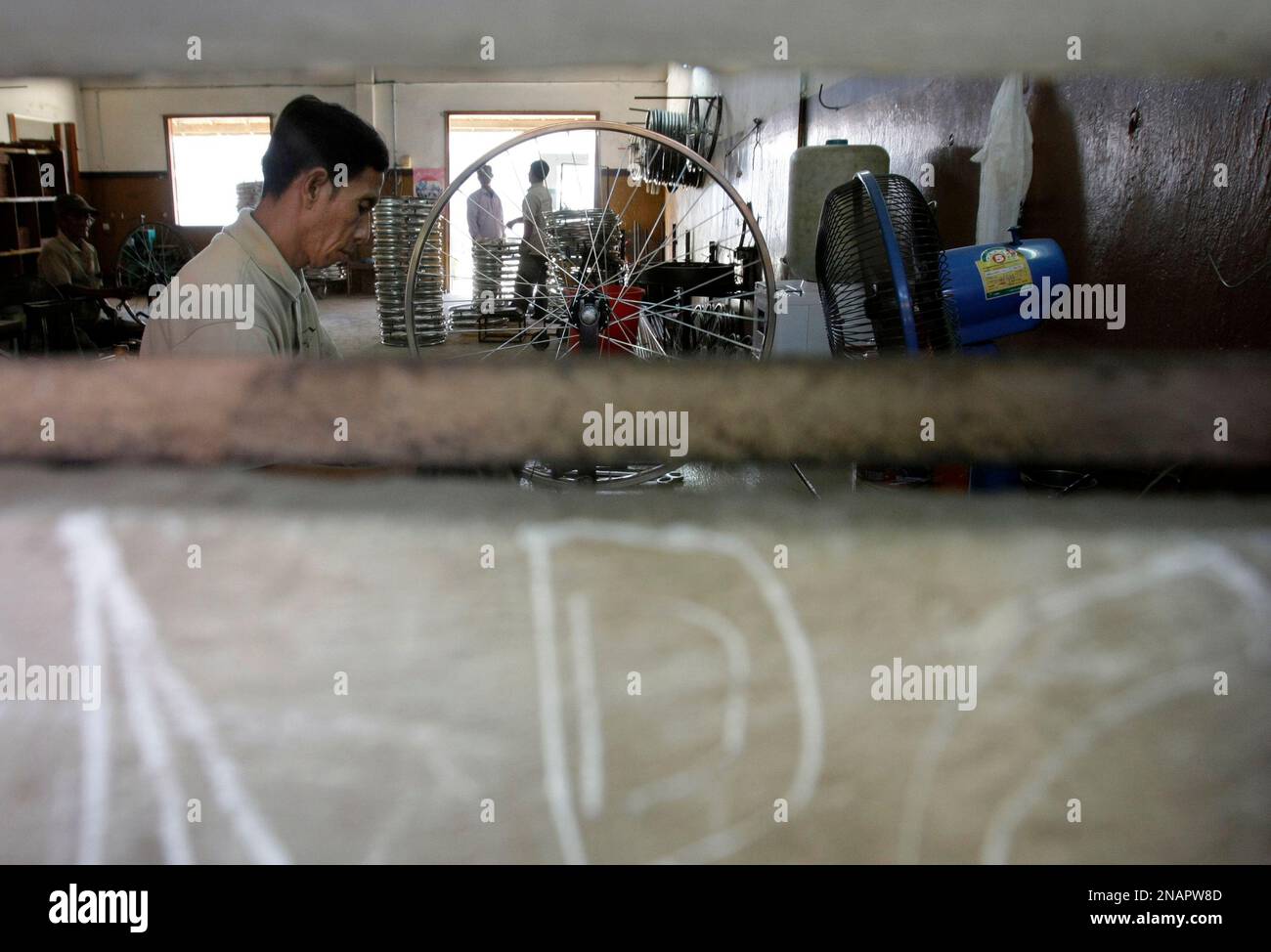 A landmine victim produces wheel chair in a rehabilitation center of ...