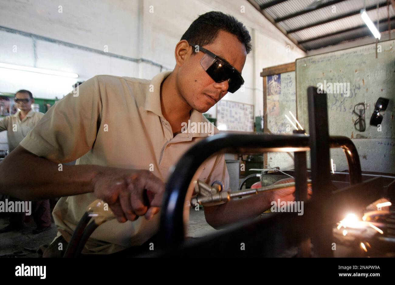 A landmine victim produces wheel chair in a rehabilitation center of ...