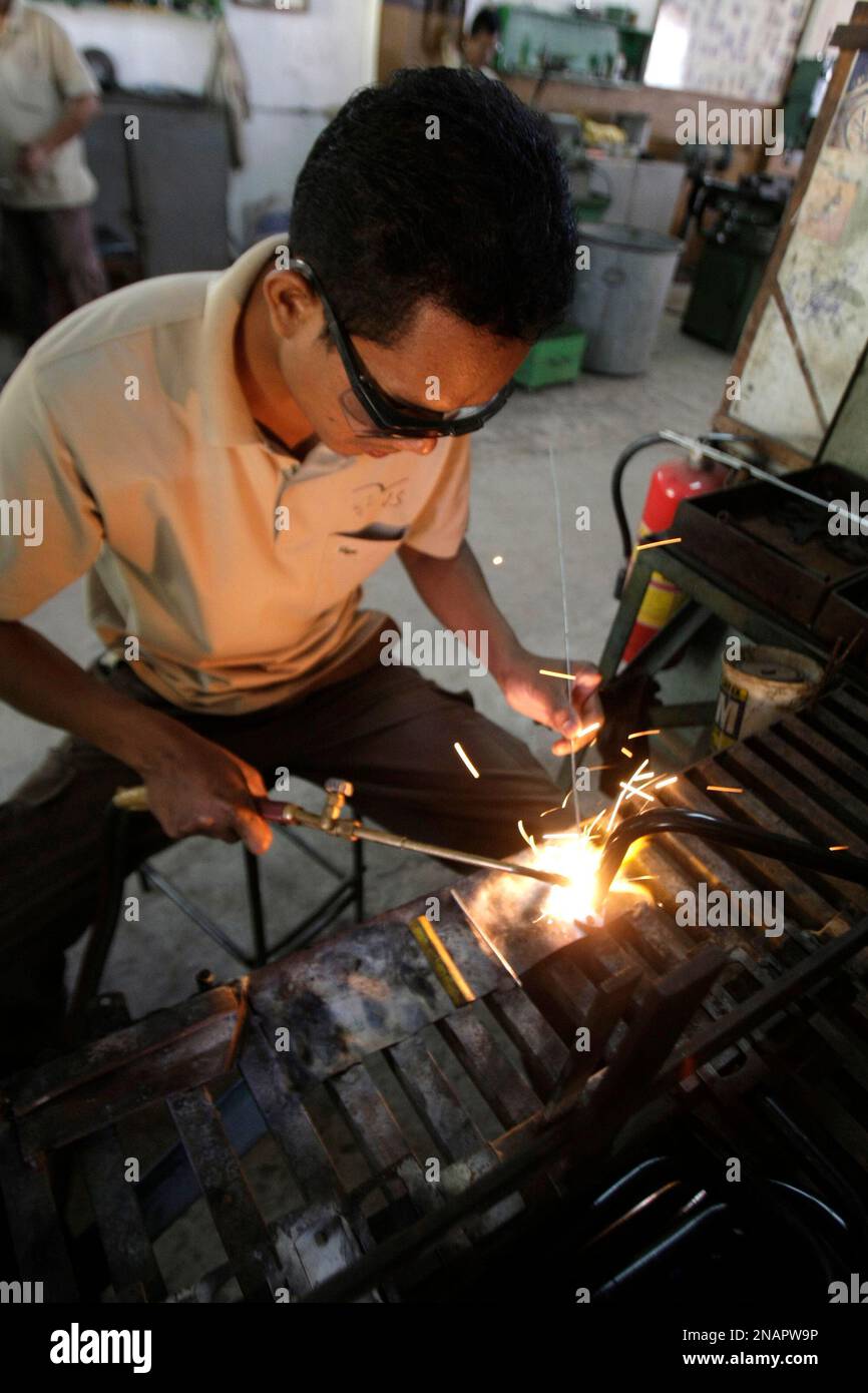 A landmine victim produces wheel chair in a rehabilitation center of ...