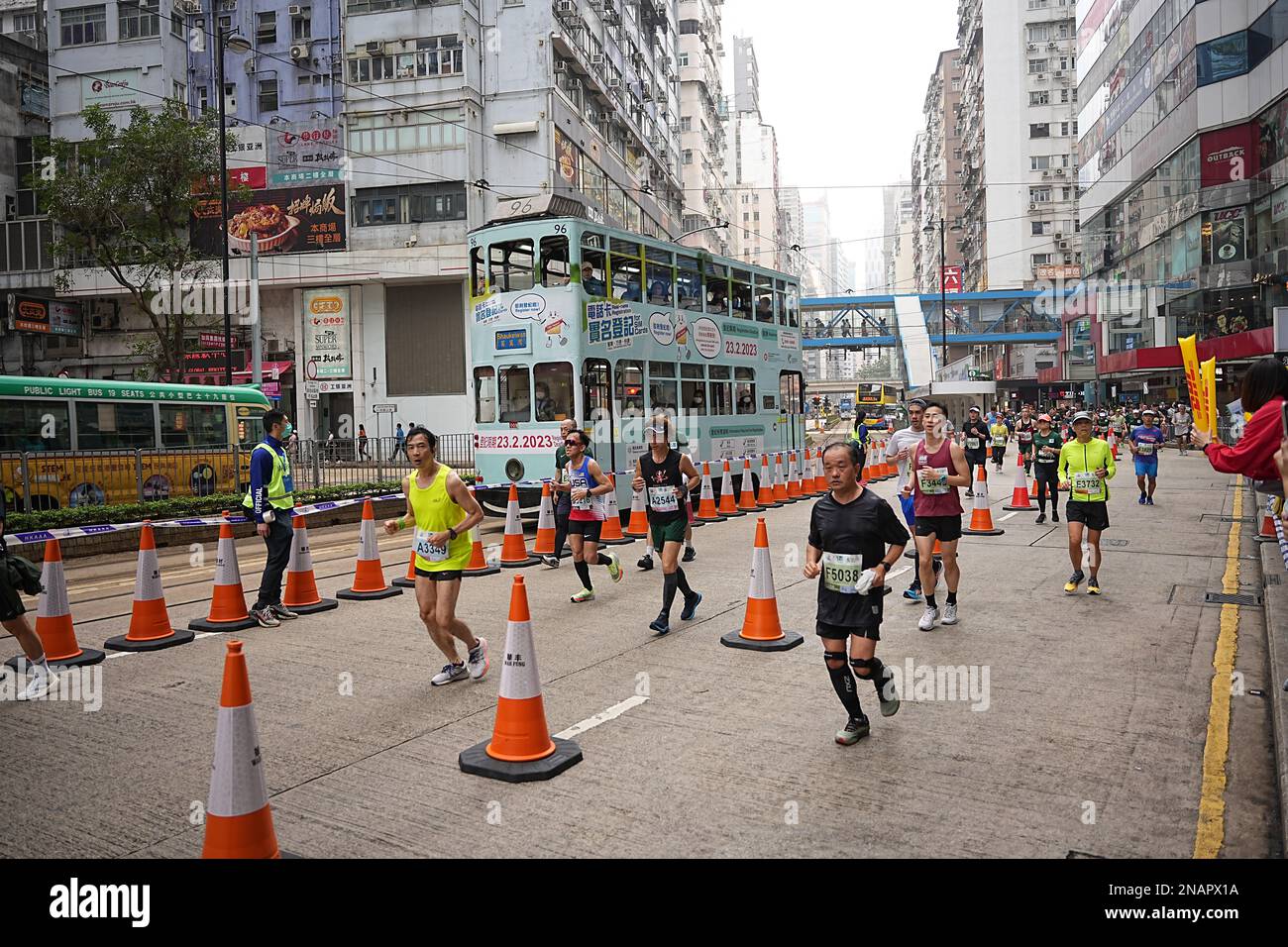 Participants run along Hennessy Road during the Hong Kong Marathon 2023 ...